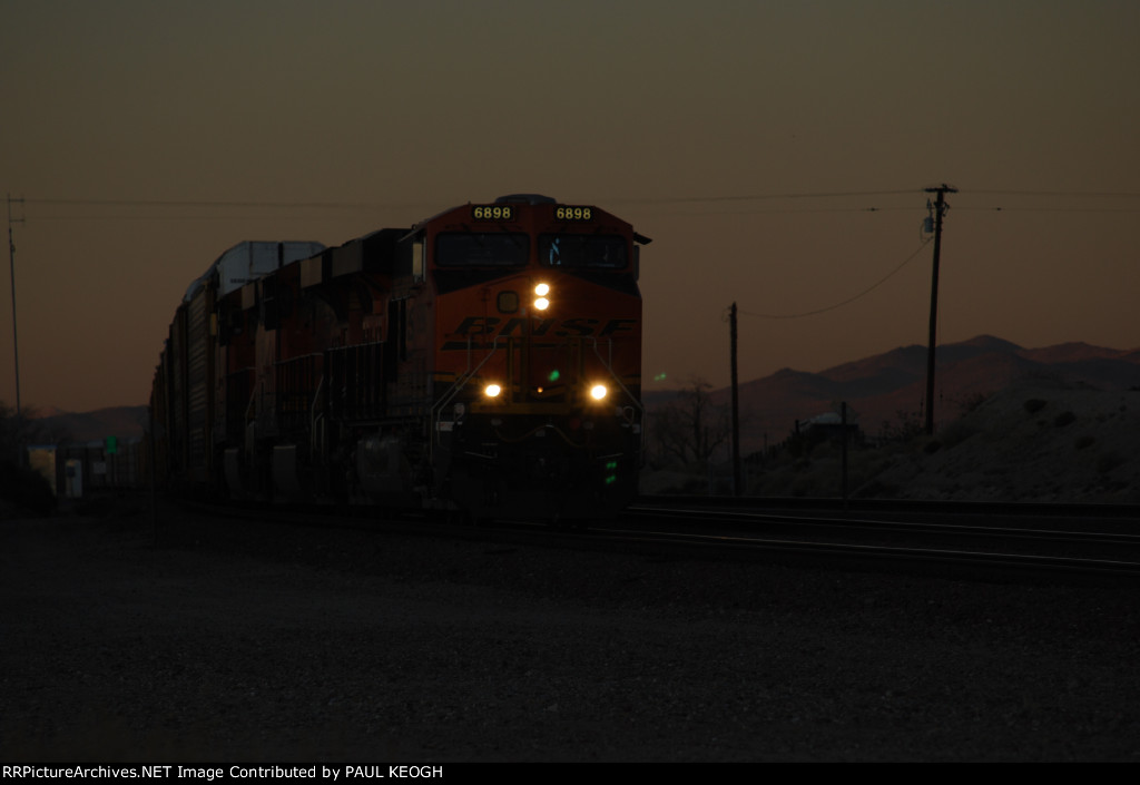 BNSF 6898 Leads a Vehicle Train east at Sunrise into the BNSF Barstow yard for a inspection at ...